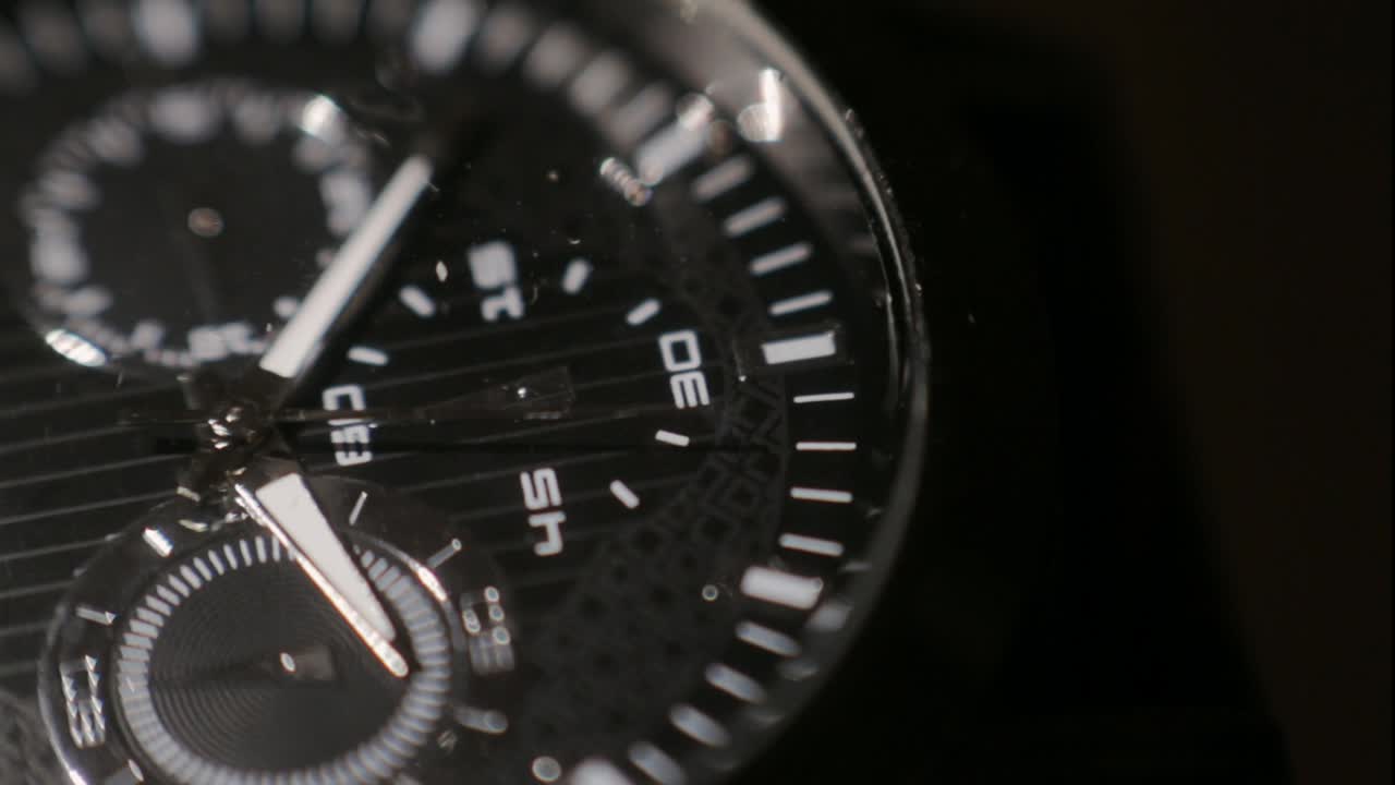Premium stock video - A beautiful black analog watch in black ...