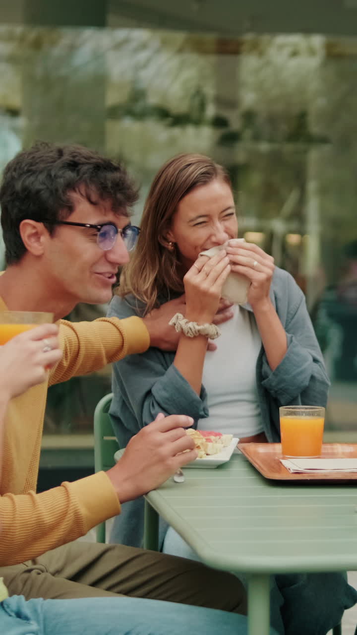 International joyful students drink soft drinks at lunch, eating ...