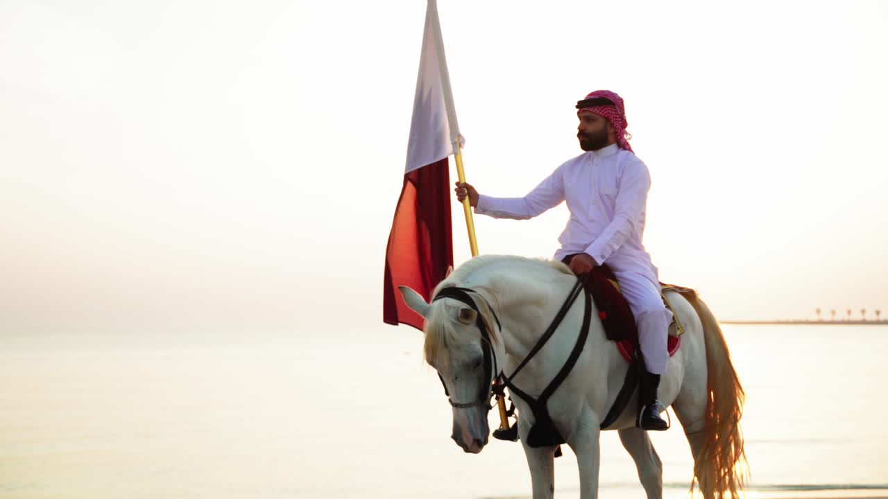 Premium stock video - A knight on a horse holding qatar flag in slow motion