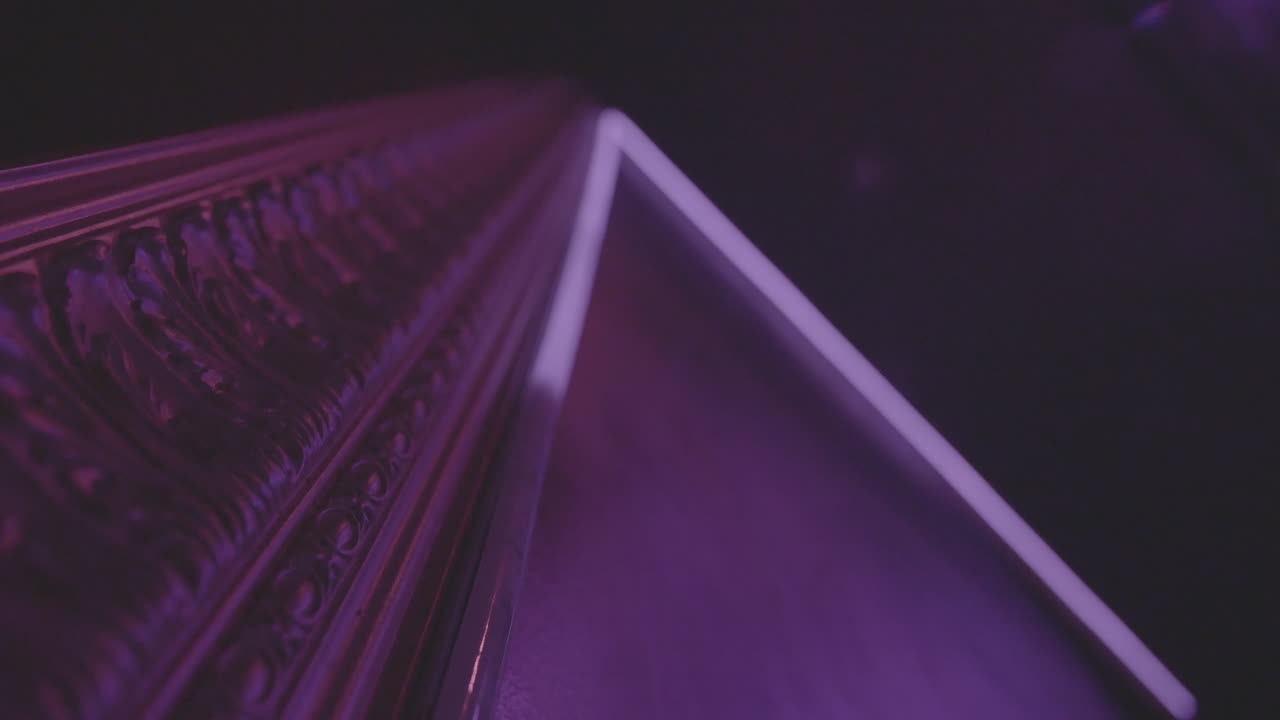 A neon tube borders the edge of an artwork frame Premium Stock Video ...