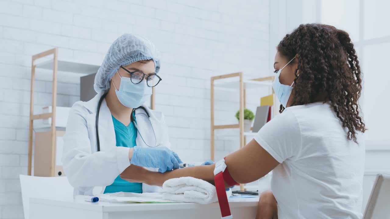 Doctor performing blood draw on patient | Premium Stock Video Footage