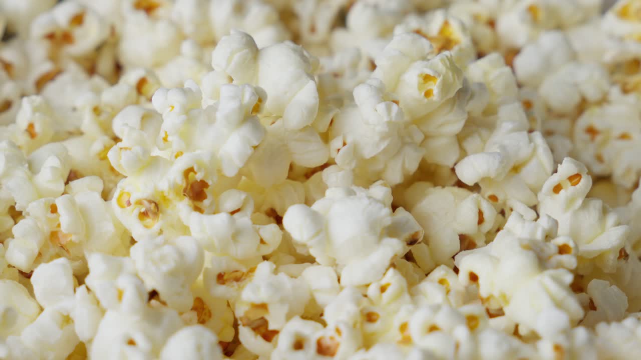 Premium stock video - Popcorn popping and falling into the pile