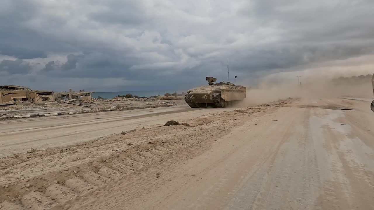 Israeli namer apc speeds along the mediterranean coastline in the gaza ...
