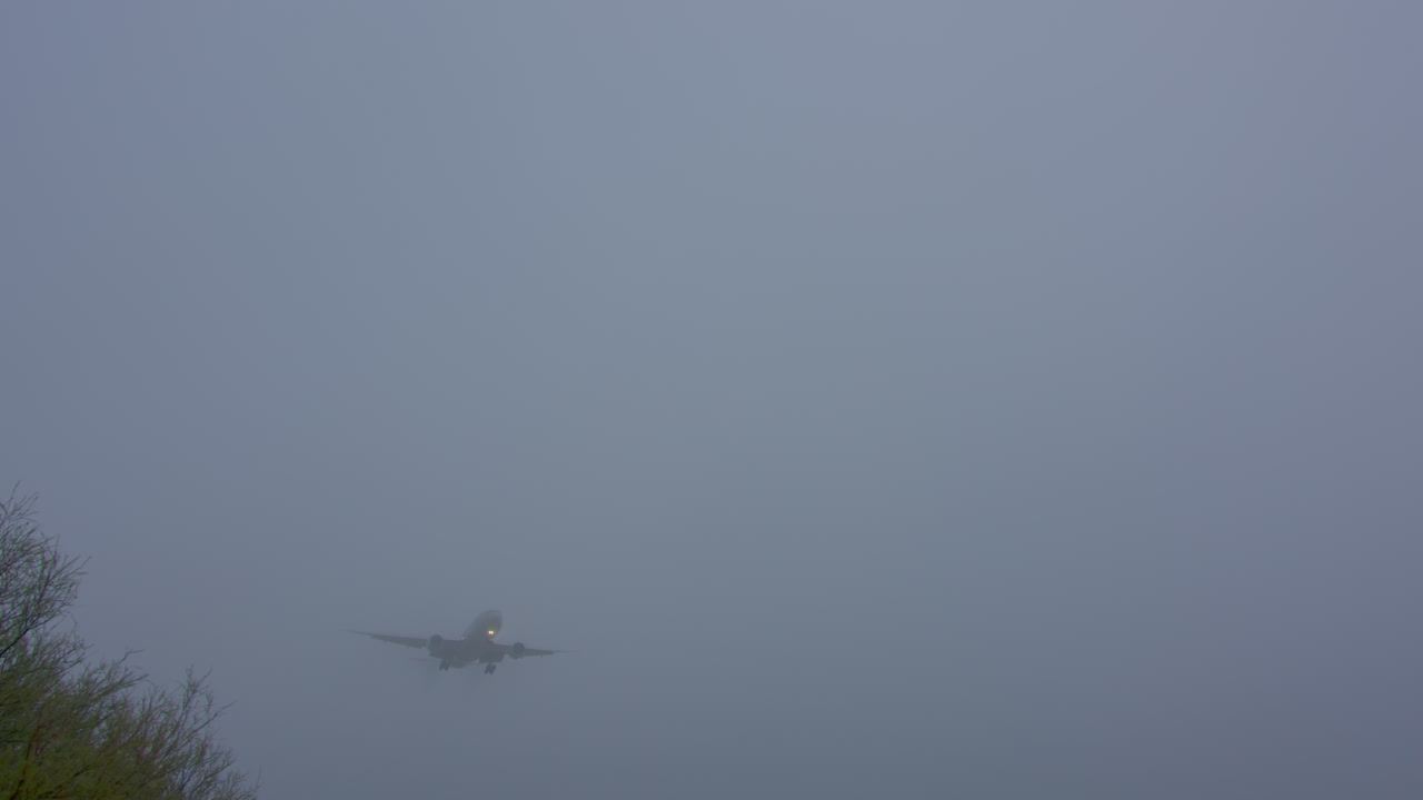 Airplane landing in fog Premium Stock Video Footage