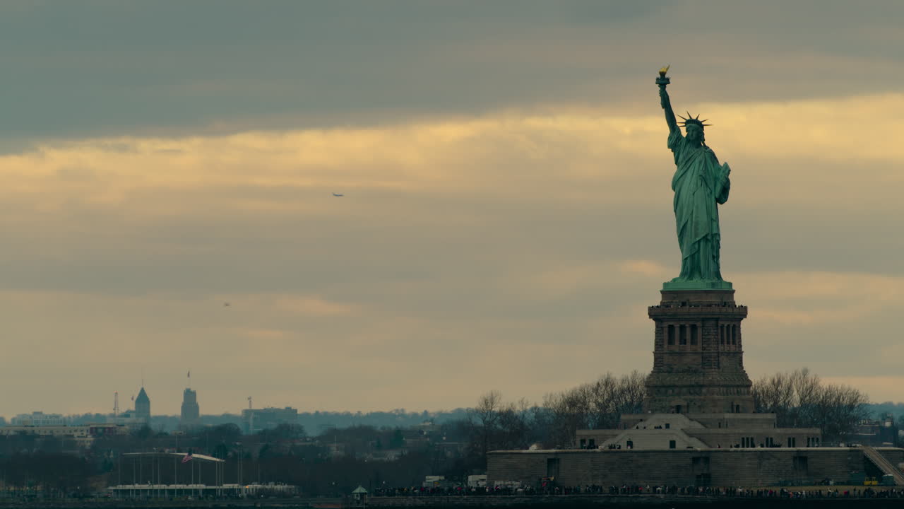 Premium stock video - Statue of liberty with colorful evening sky