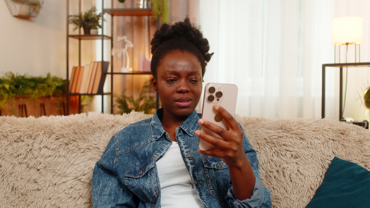 African american sad amazed woman reacts with shock while reading ...