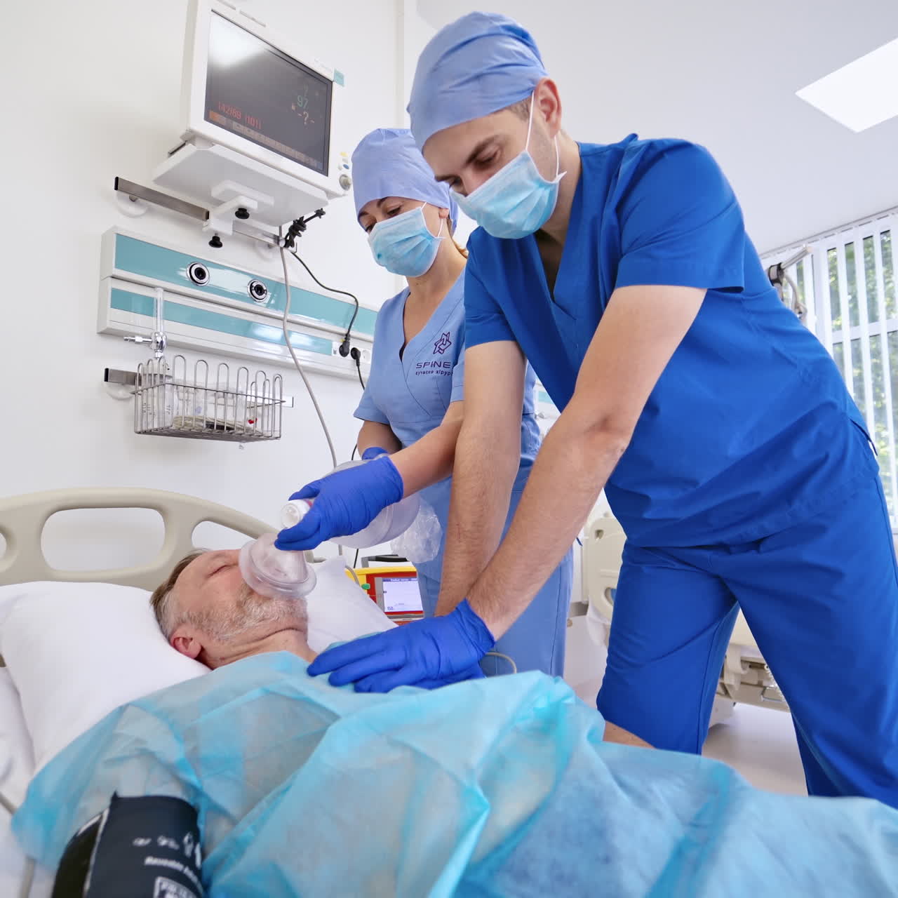 Doctor and a nurse give resuscitation to a male patient in the ...