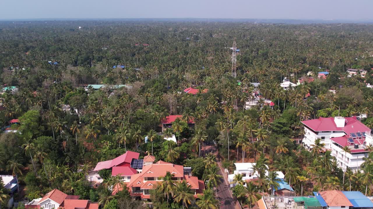 Premium stock video - Varkala aerial shot of forest and buildings