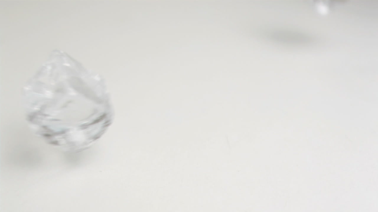 Premium stock video - Ice cube rolling in super slow motion