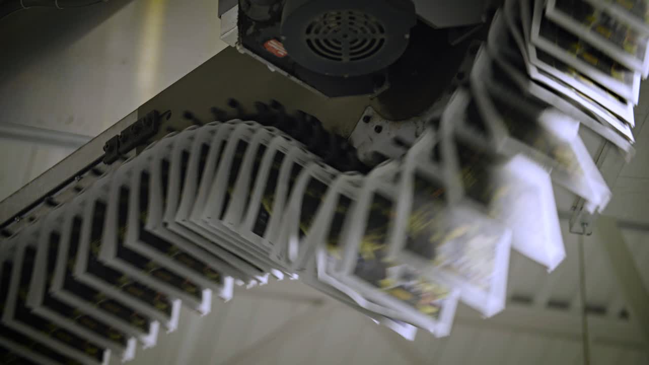Newspapers Move Along An Overhead Conveyor Belt At A Newspaper Factory ...