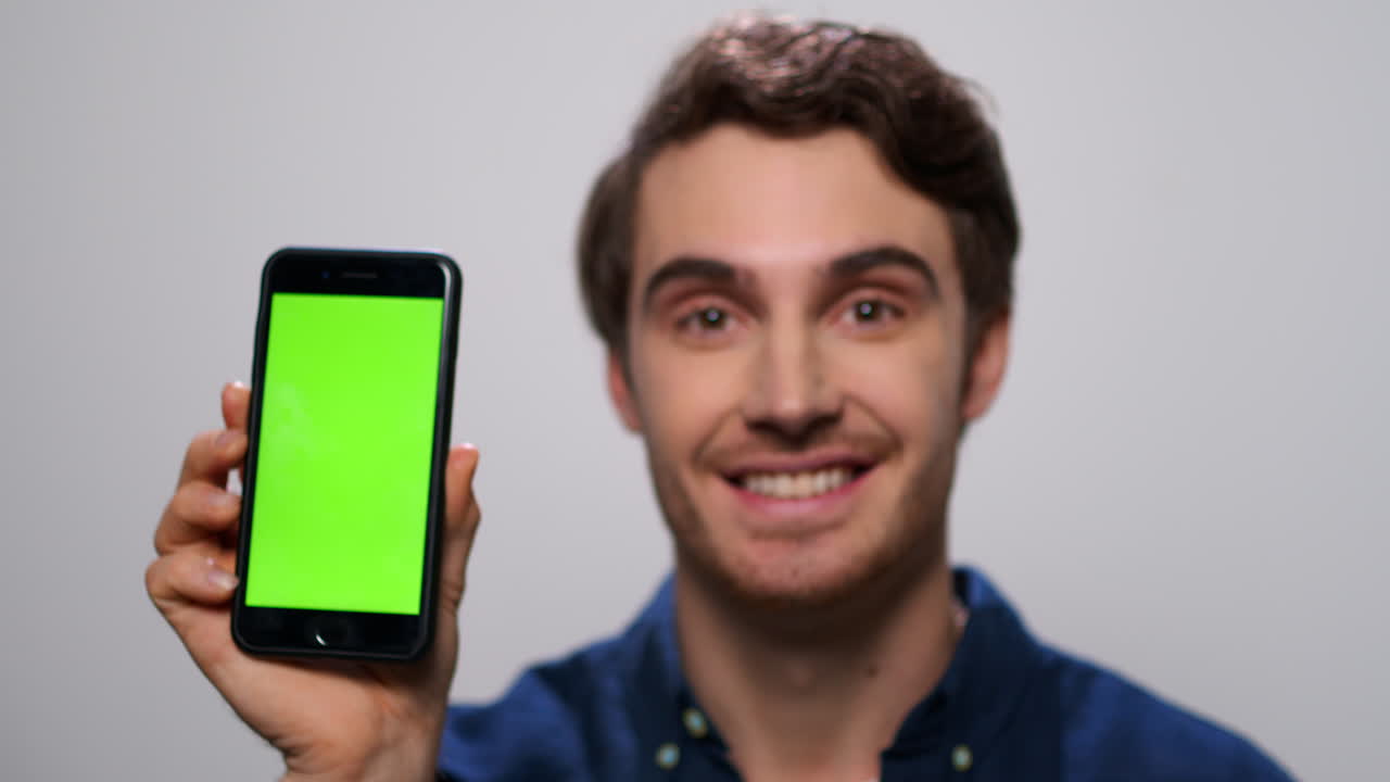 Man Showing Smartphone With Green Screen. Male Showing Phone With ...