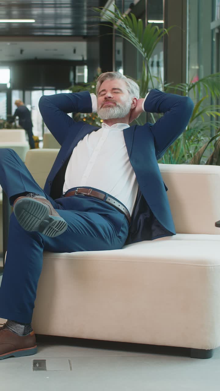 Caucasian businessman taking break leaning on couch after working ...