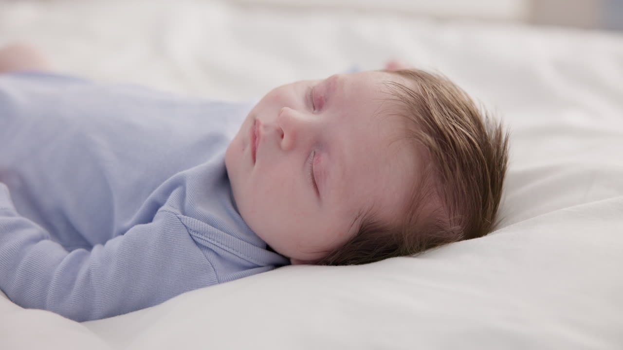 Relax, growth and sleep with a baby on a bed | Premium Stock Video Footage