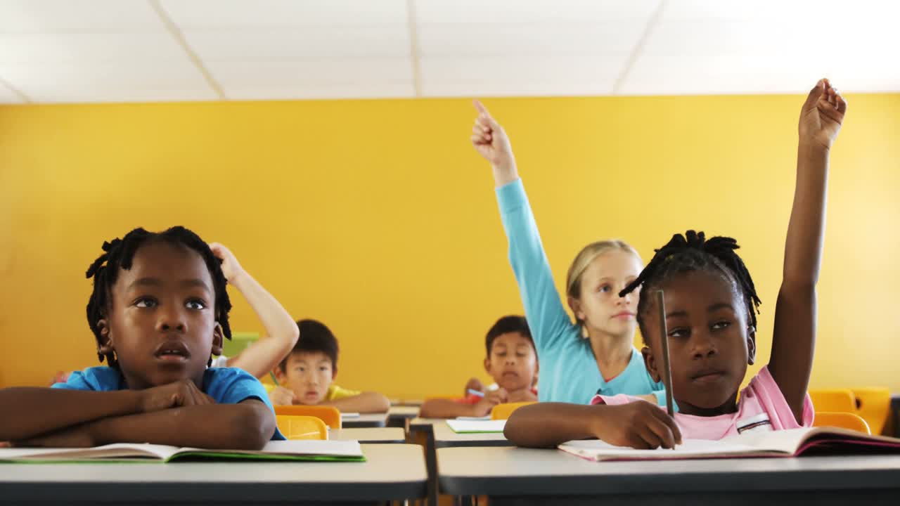 Premium stock video - School kids raising hand in classroom