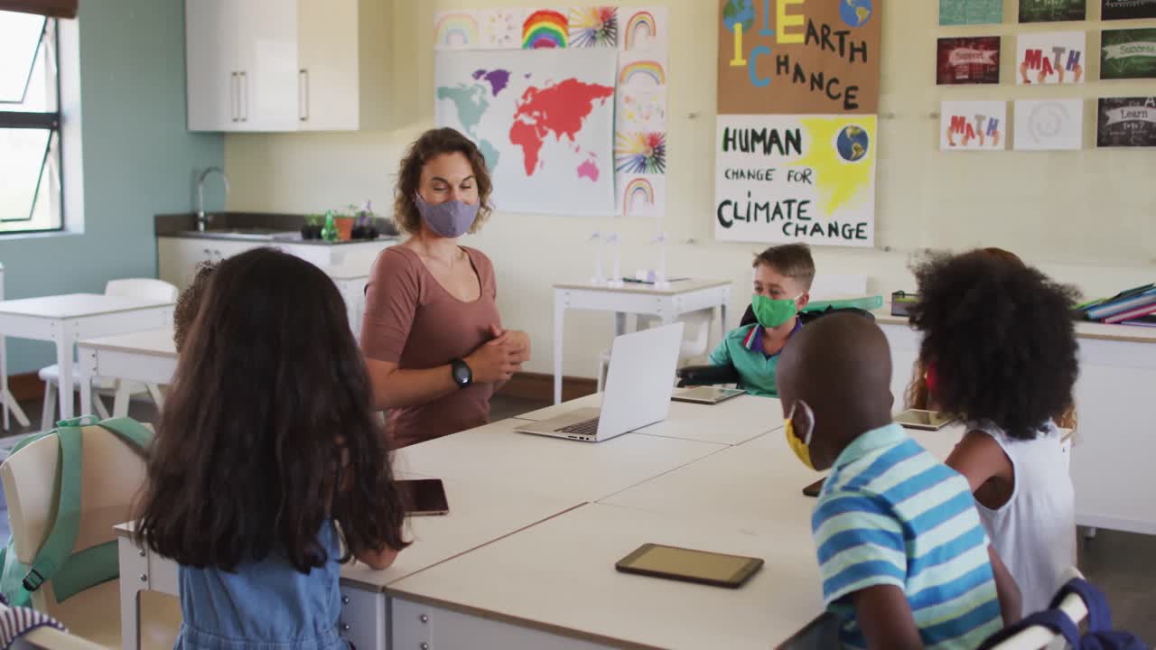 Female Teacher Wearing Face Mask Teaching Kids In The Class At School ...
