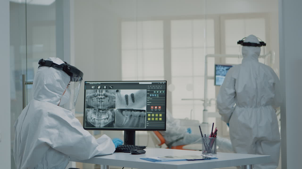 Premium stock video - Professional dentistry staff with ppe suit ...