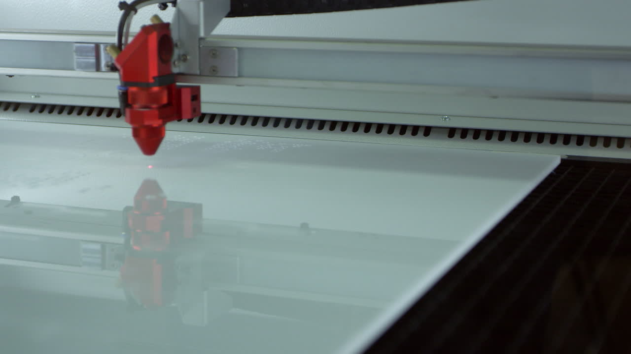 A laser cutter in operation at a 3d printing lab, shot on r3d Premium ...