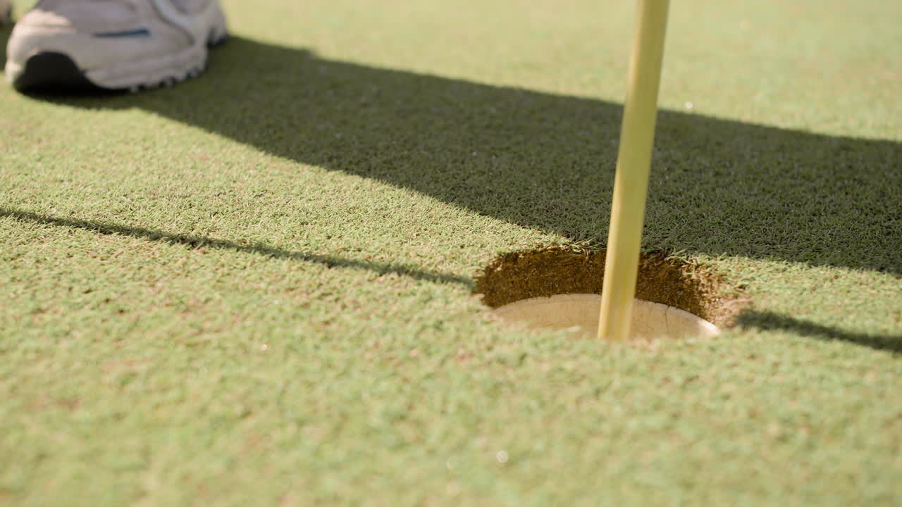 Free stock video - Closeup golf ball getting inside hole