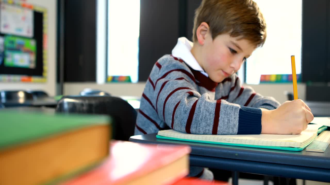 Boy doing homework in classroom 4k | Premium Stock Video Footage