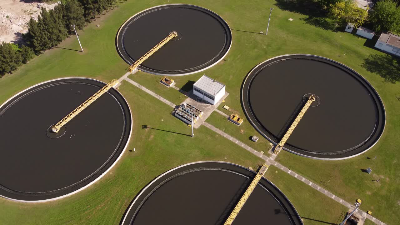 Aerial tllt down shot of environmental water filtration pools at Sewage ...