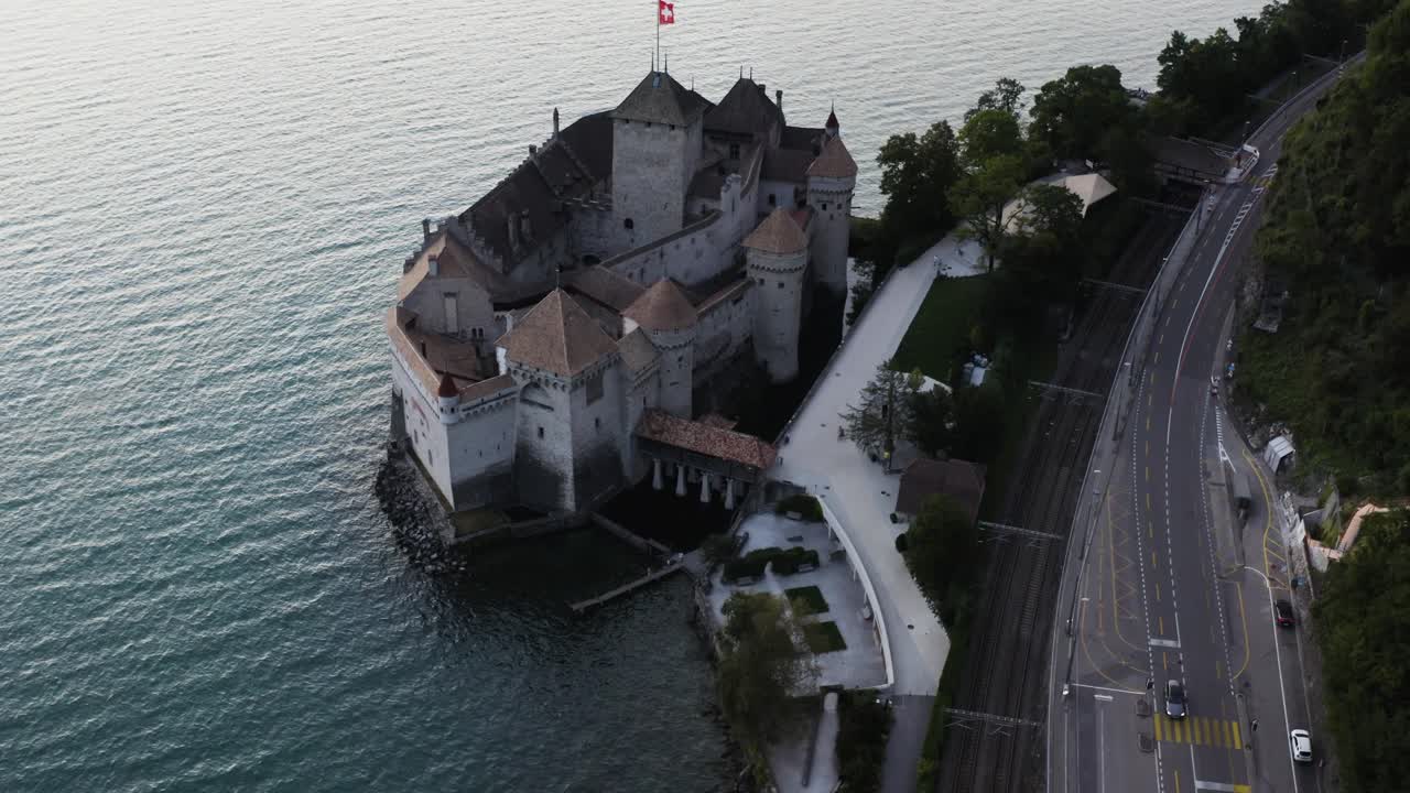 Aerial shows chillon castle from above and tilting up to lausanne city ...