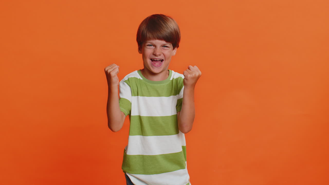 Young preteen child boy kid celebrating success winning birthday ...