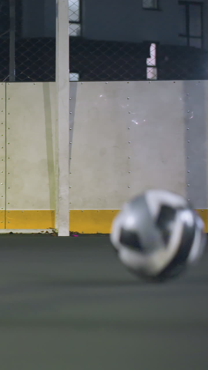 Soccer ball rolling on sports field as it is trapped by a player ...