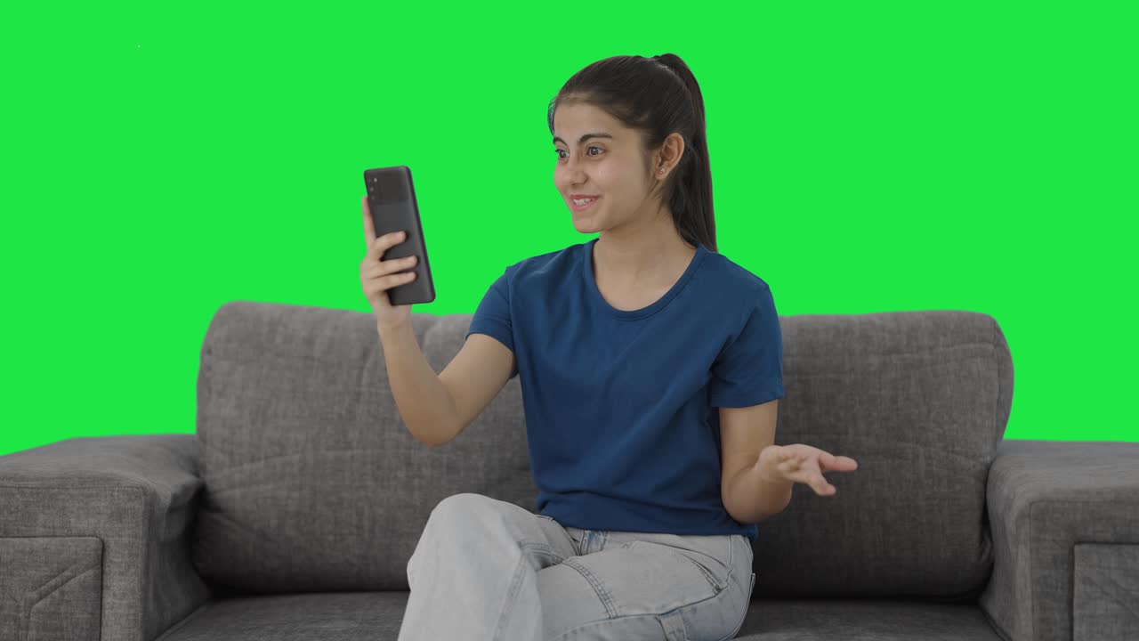 Happy Indian teenage girl talking on video call Green screen | Premium ...