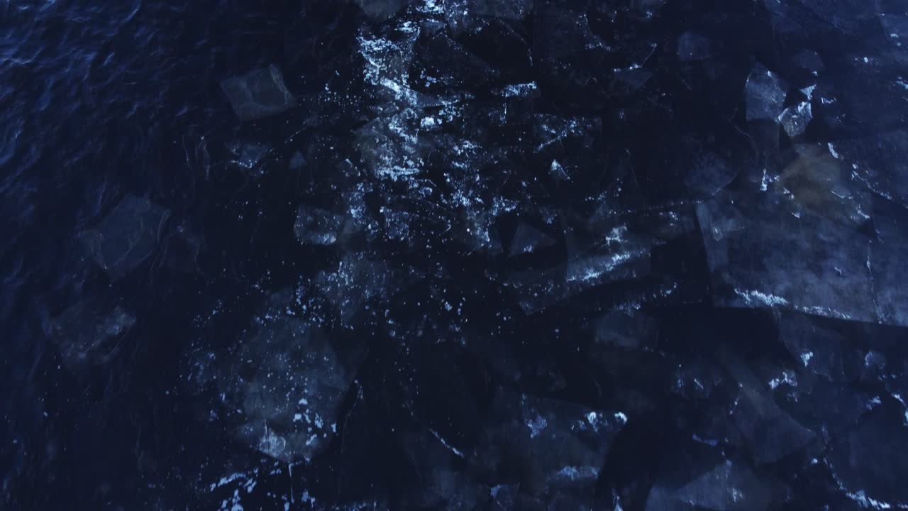 Large Ice Blocks Floating In Dark Deep Water, Aerial Downwards View ...