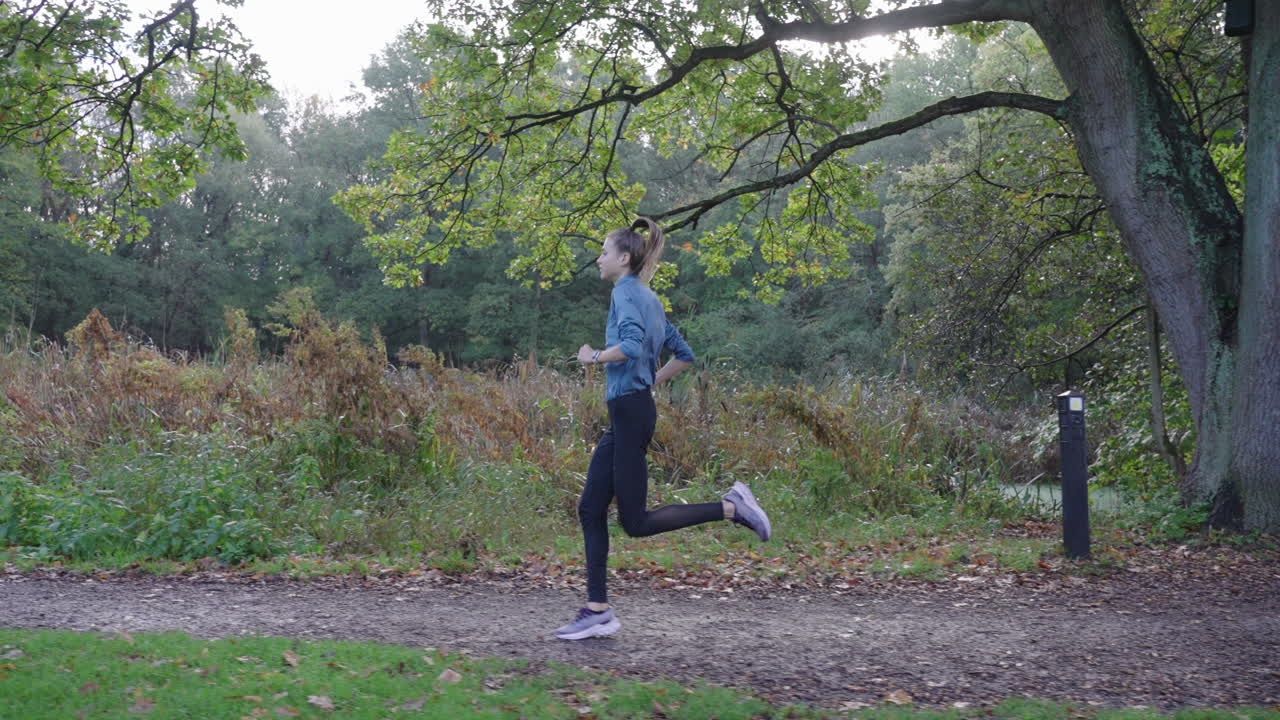 Captivating Side-tracking Shot: Camera Glides Backward As Woman Runs ...