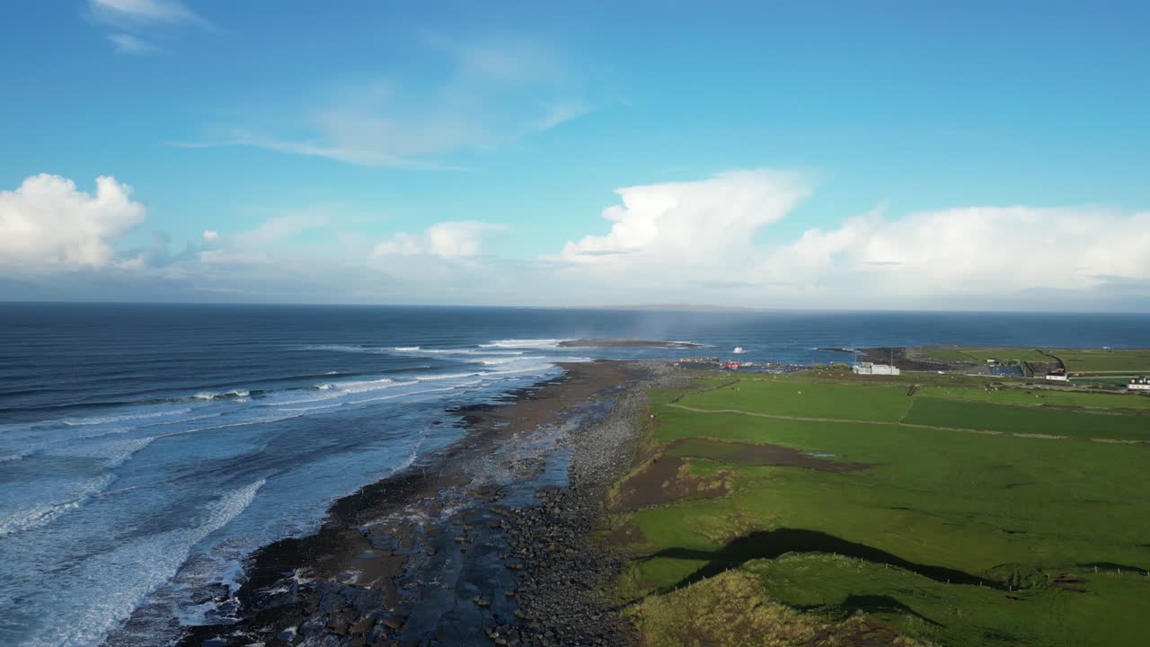 Slow establishing shot of waves crashing on Doolin bay in Ireland ...