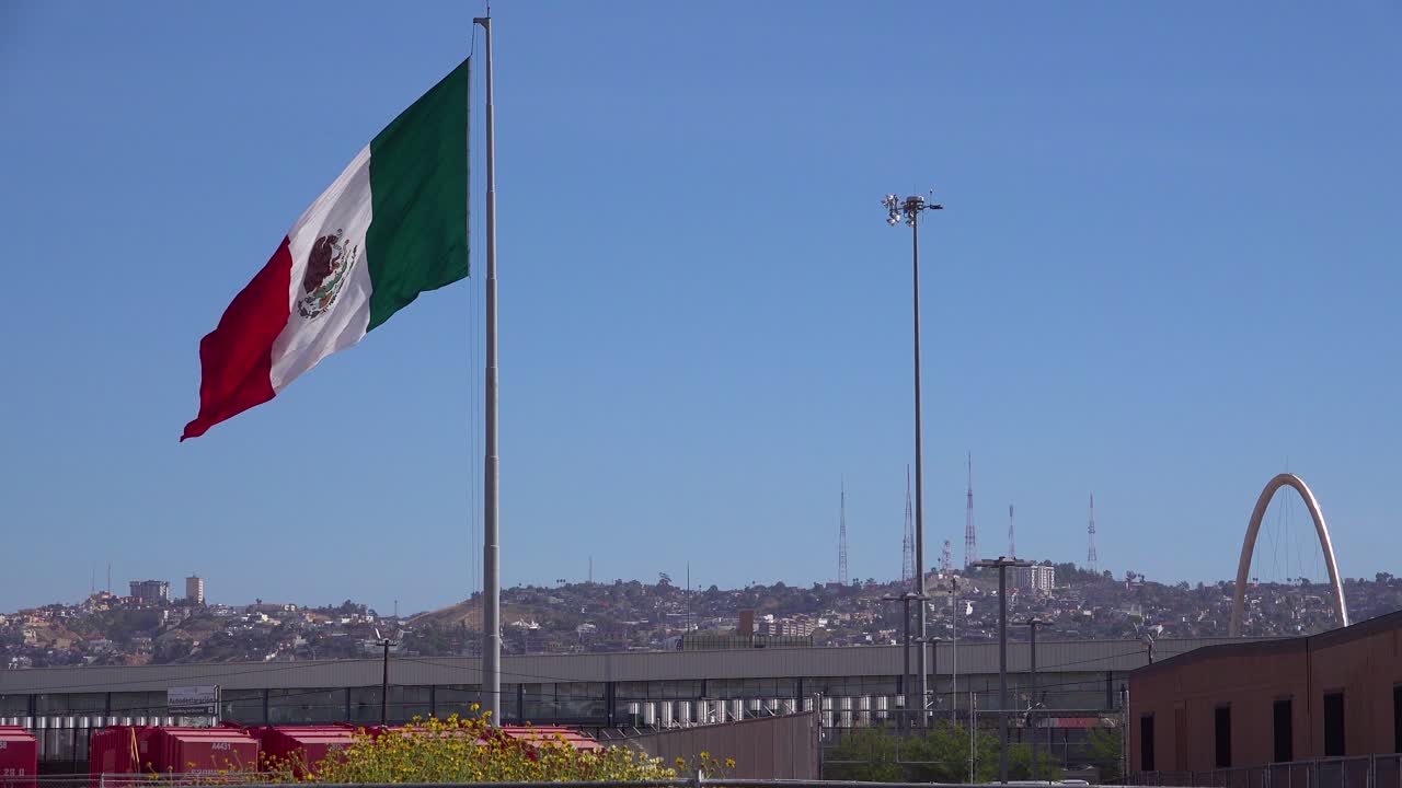 Premium stock video - The mexican flag flies along the us border in ...