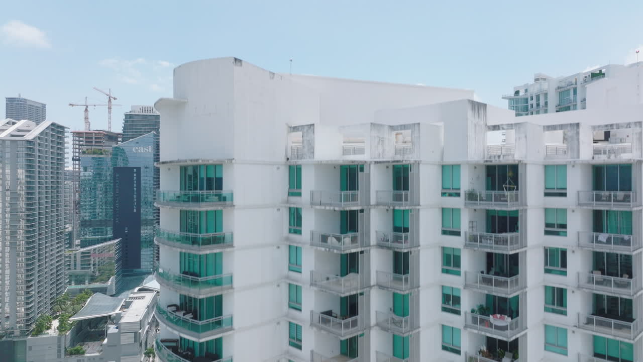 Premium stock video - Rising shot of apartment building facade with ...