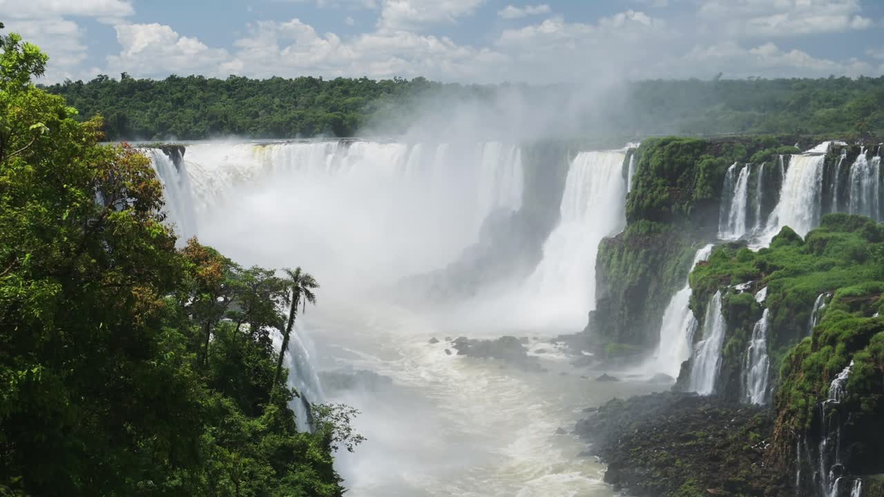 Beautiful trees and green scenery with large group of huge waterfalls ...