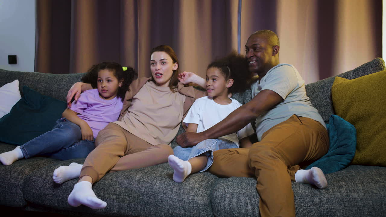 Free stock video - Family watching video at home