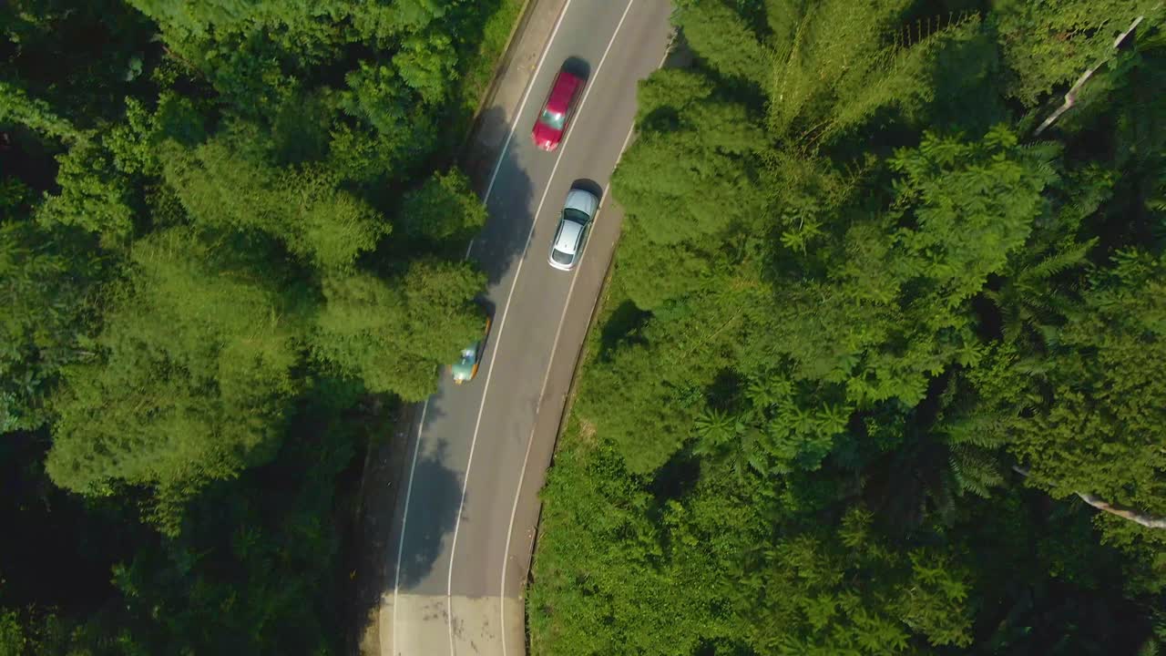 Premium stock video - Birds eye view of car on curve road up the hill