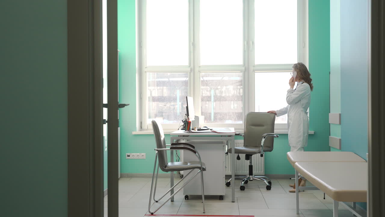 Free stock video - Female doctor talking on phone with patient and ...
