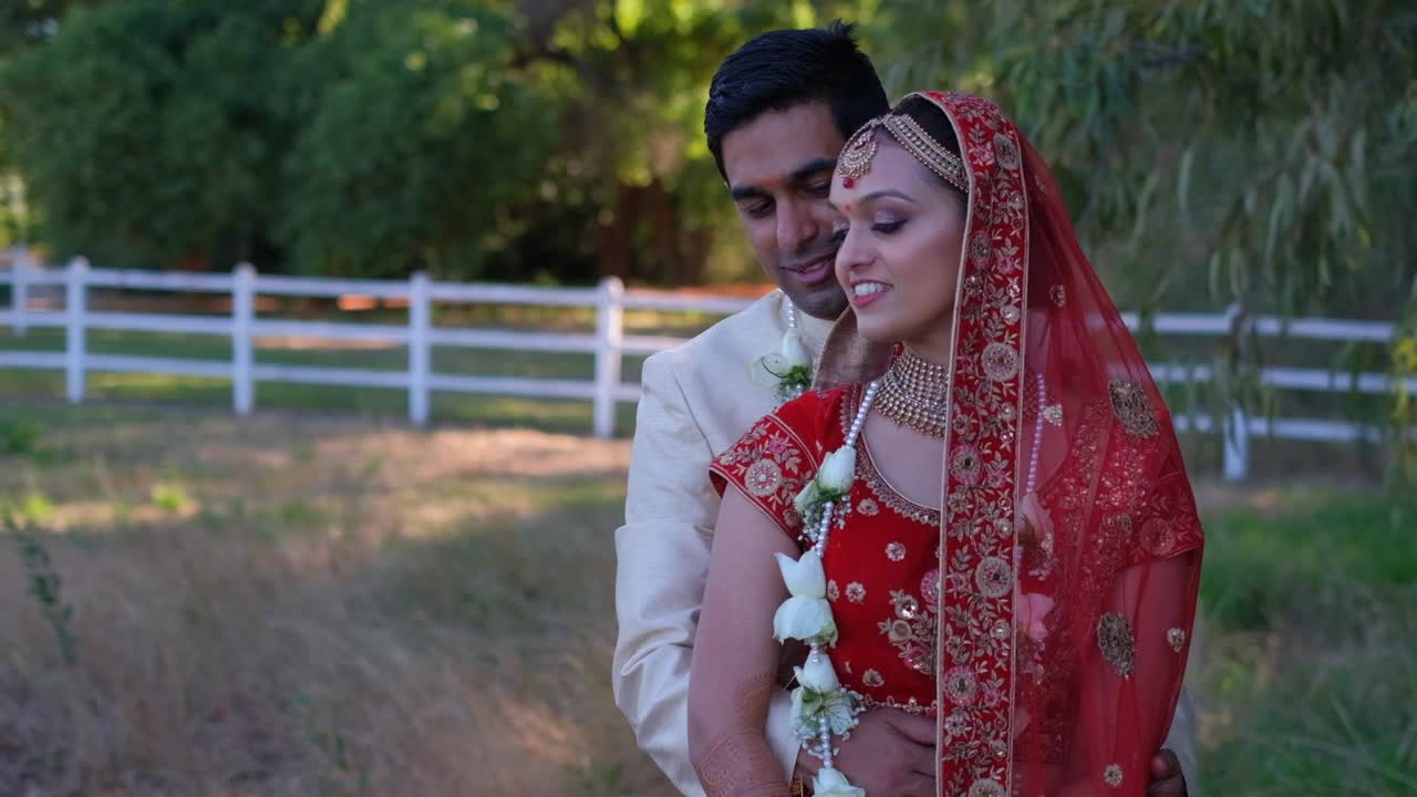 Premium stock video - Indian groom hugging the bride from the back ...