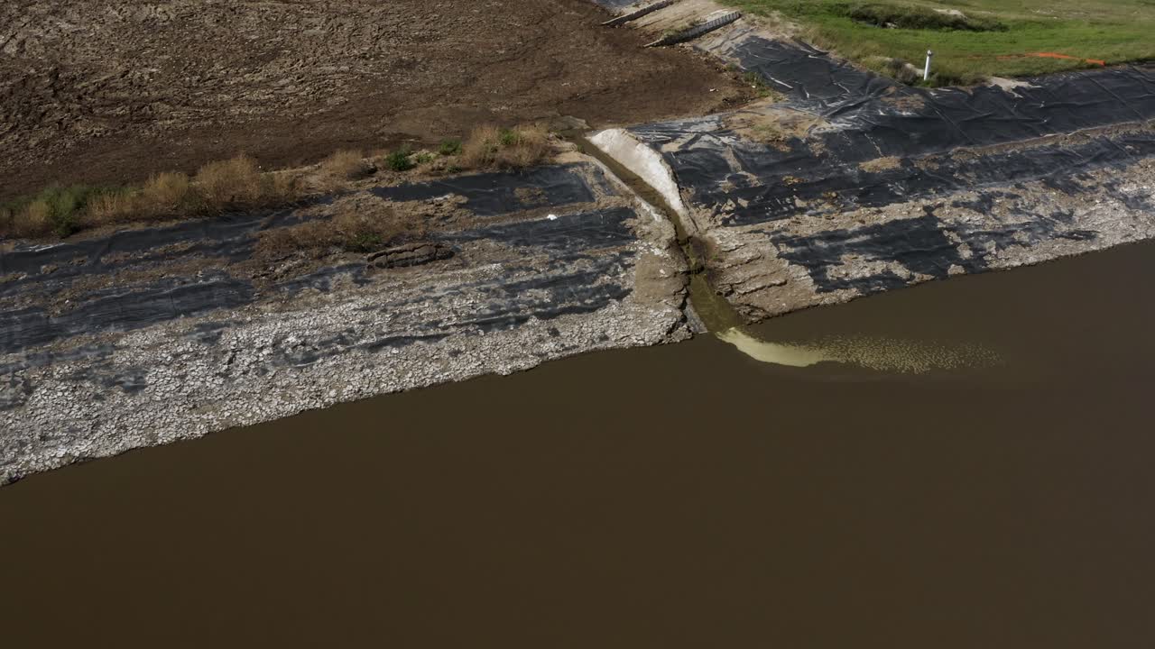 Premium stock video - Aerial shot of a manure lagoon over flow spout ...