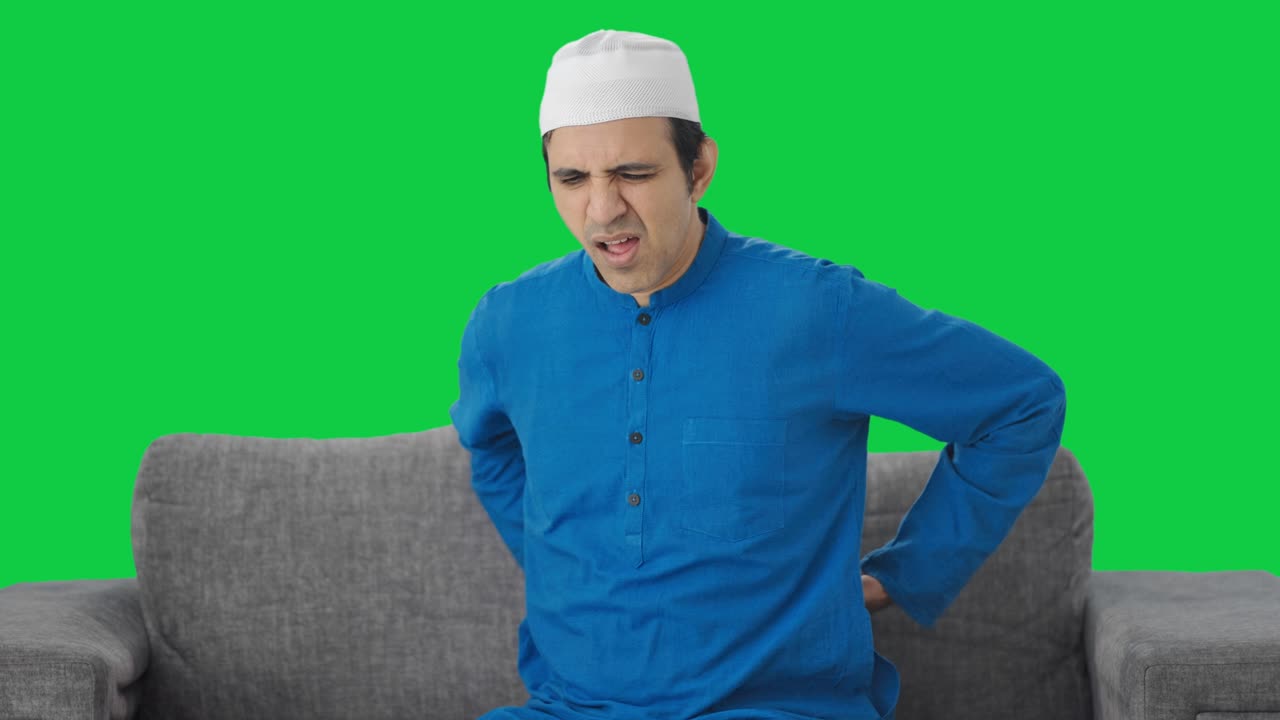 Premium stock video - Sick muslim man suffering back pain green screen