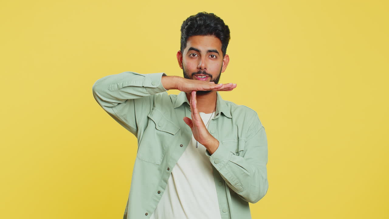 Tired upset Indian man showing pause gesture, limit or stop sign, time ...