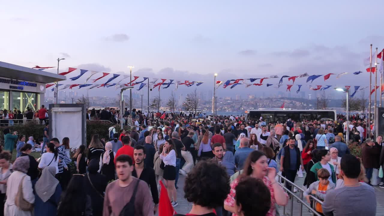 Premium stock video - A large crowd of people gather in a city street ...