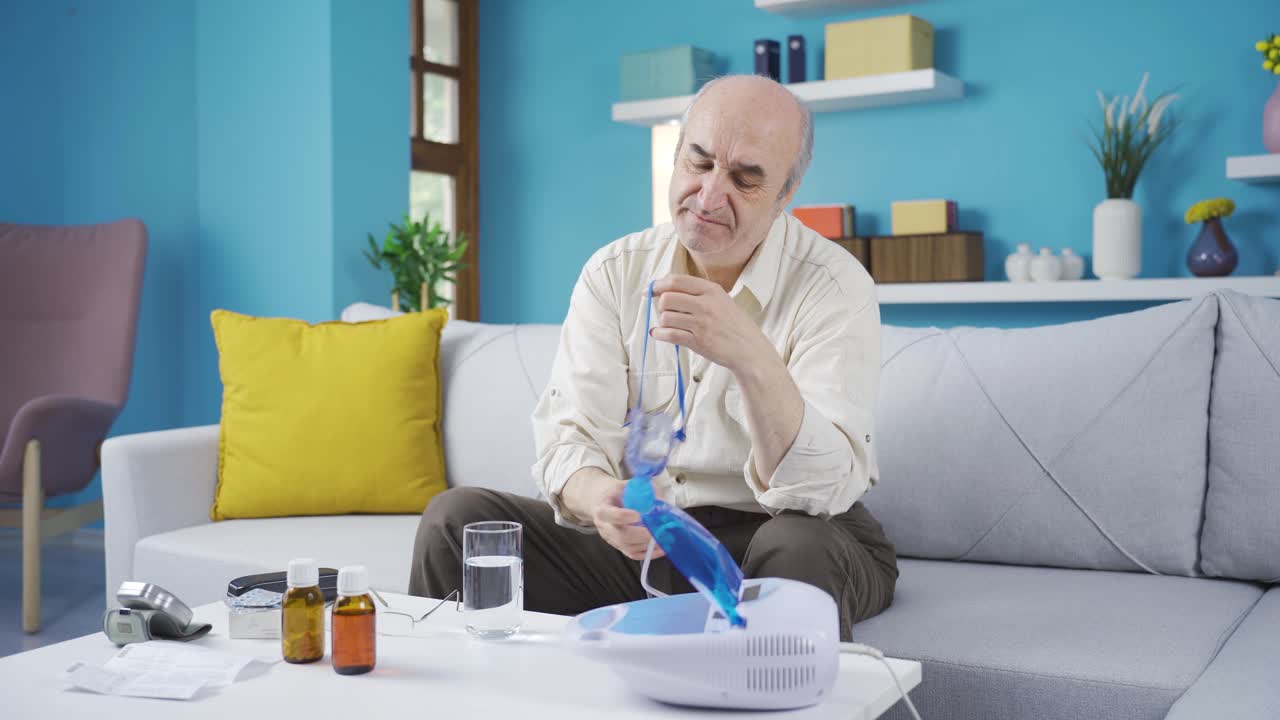 Wheezing Man Using Respirator. Free Stock Video Footage Download Clips