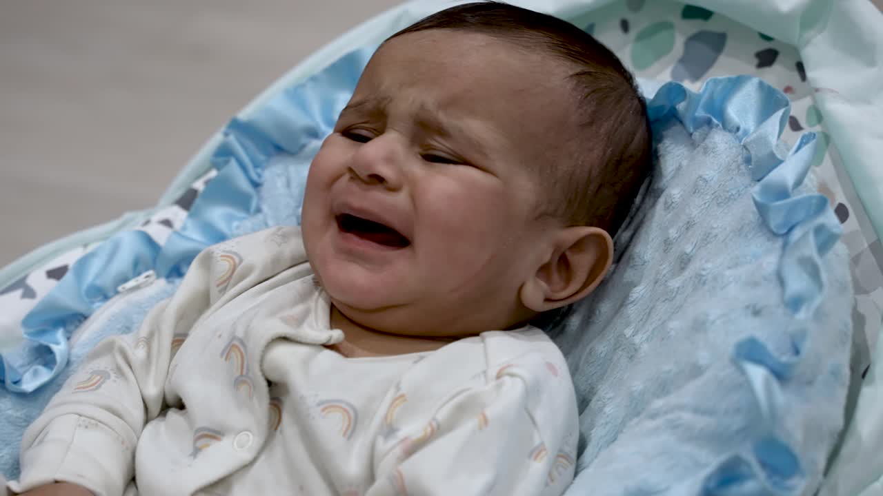 British Asian 6 Month Old Baby Crying And Looking Agitated Whilst In ...