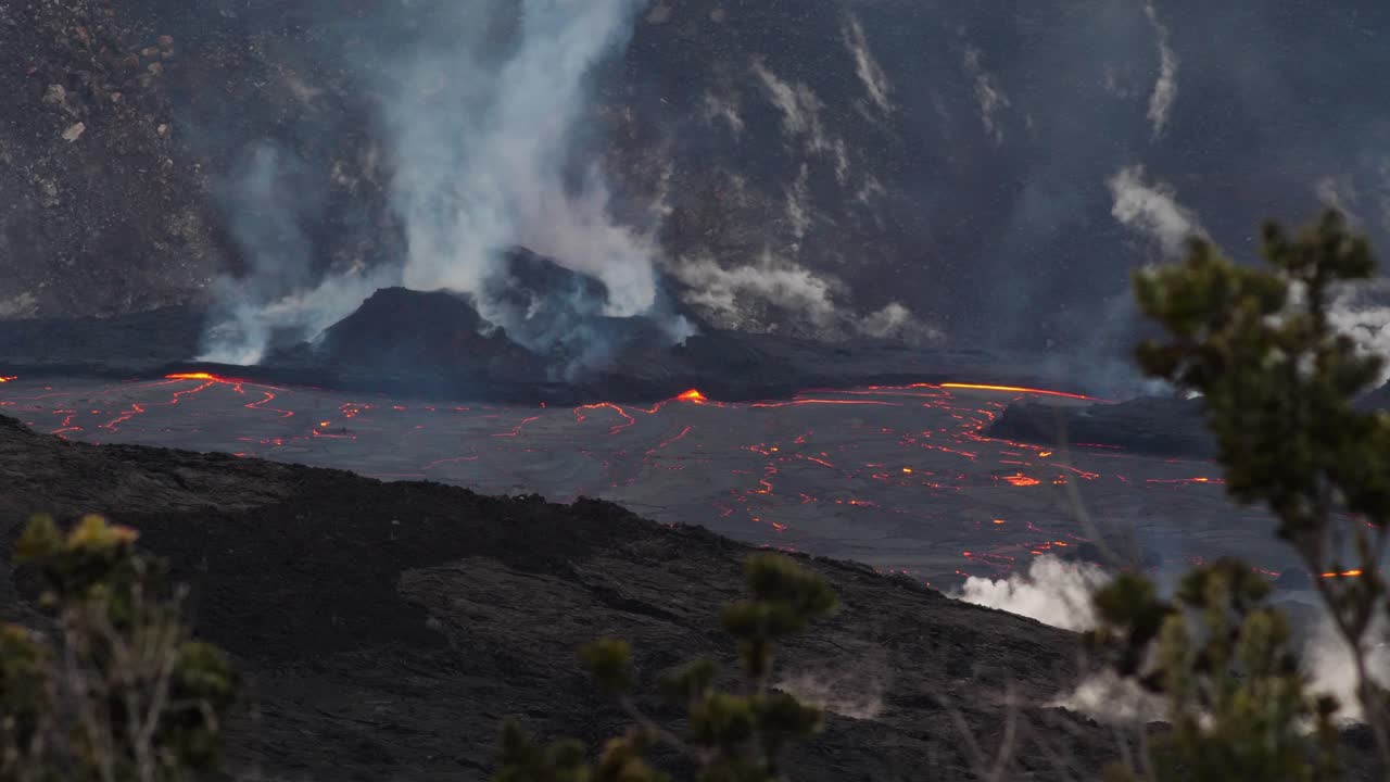 Light gray smoke and steam rises off the centralized spot of magma ...