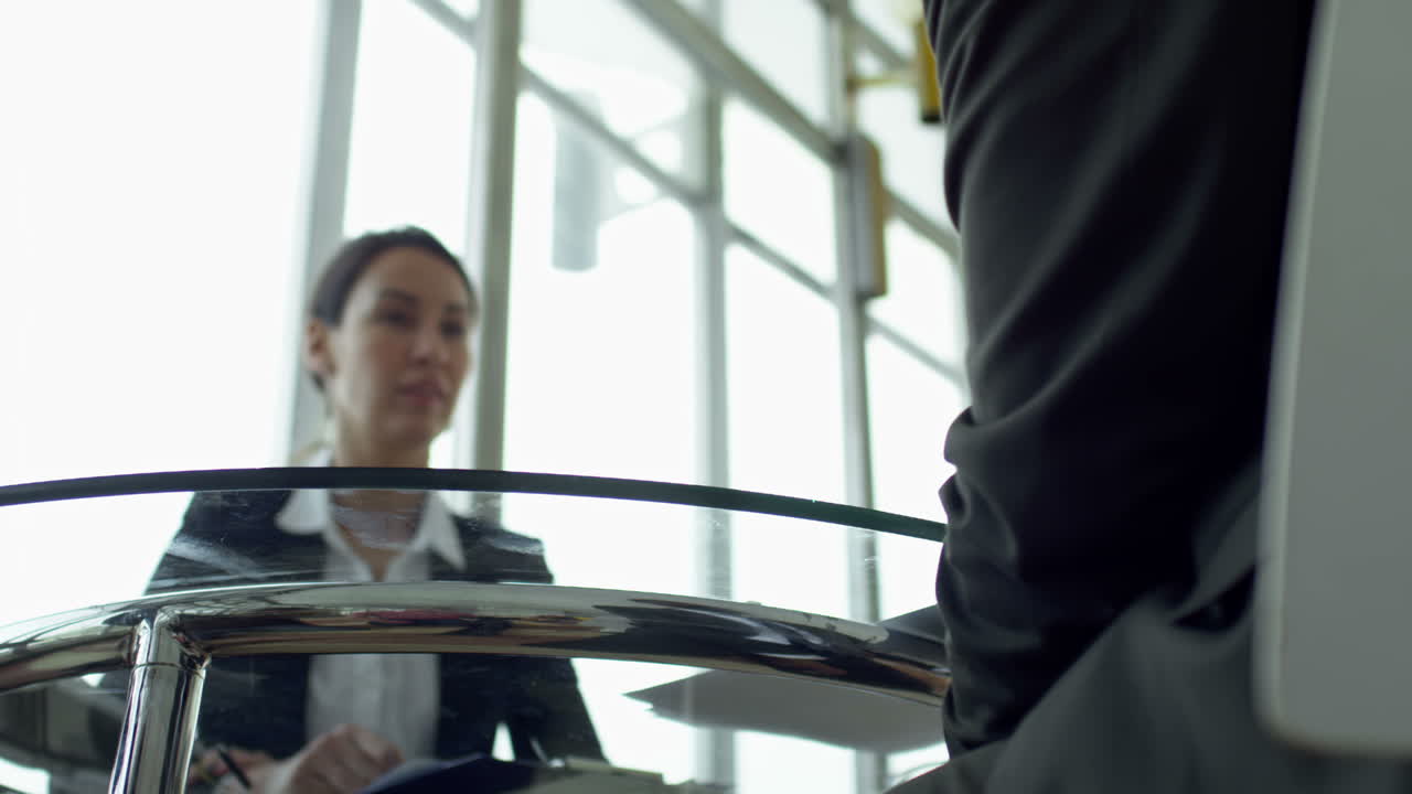 Bottom view of businesswoman in a meeting with coworkers sitting at a ...