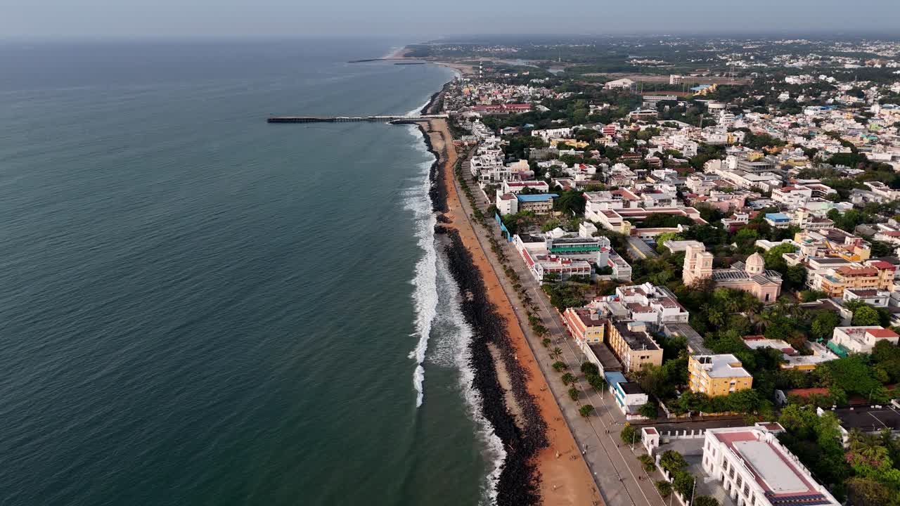 Parallax shot Aerial footage of the Puducherry shoreline featuring a ...