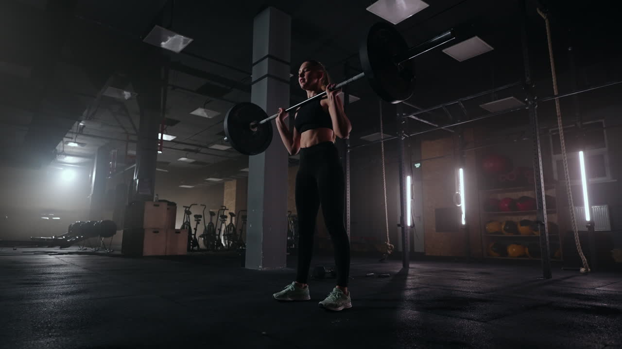 Athletic Beautiful Woman Does Overhead Deadlift With A Barbell In The ...