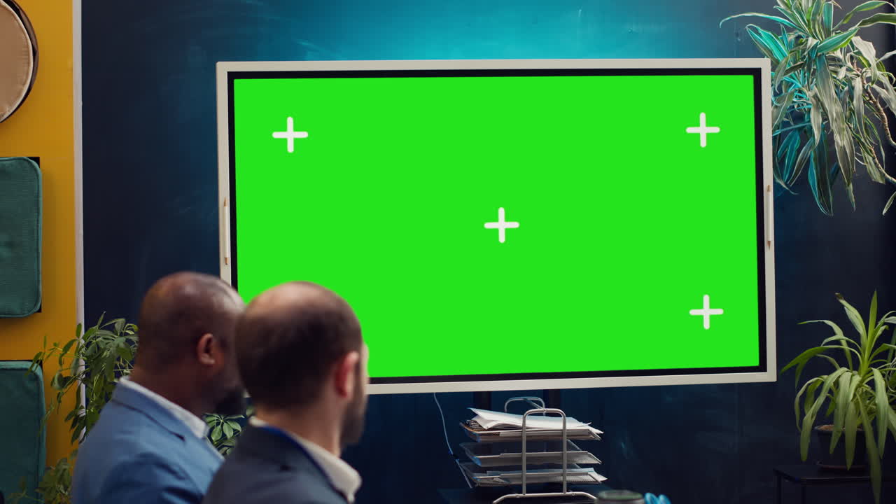 Premium stock video - Promotions manager and team members watching a ...