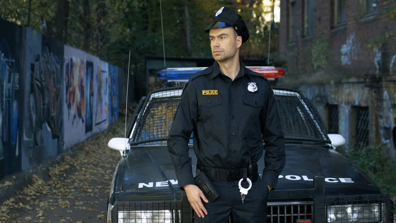Free stock video - Portrait of handsome policeman in uniform looking ...